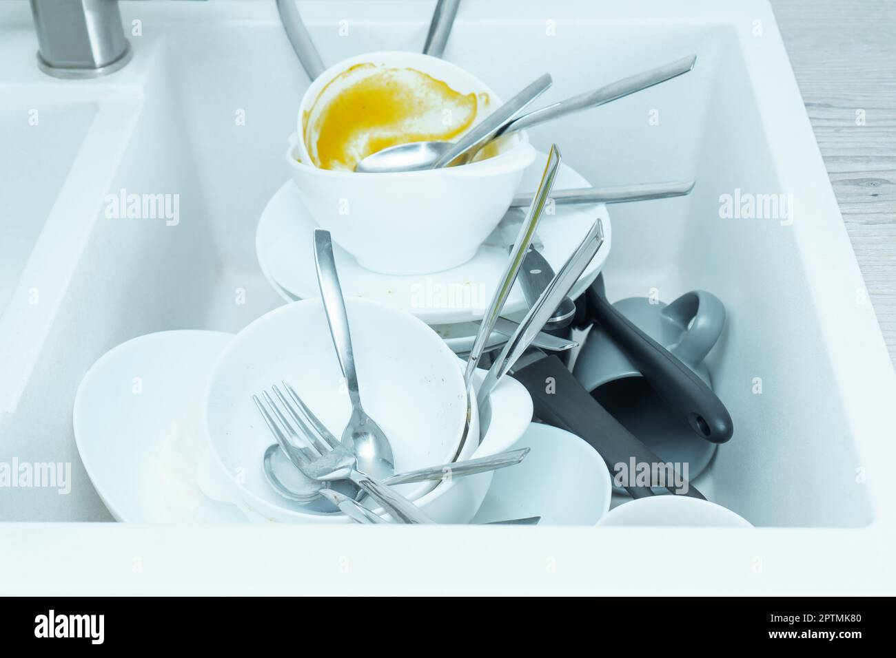 Sink full of pile of dirty tableware closeup. Dish washing, tableware ...