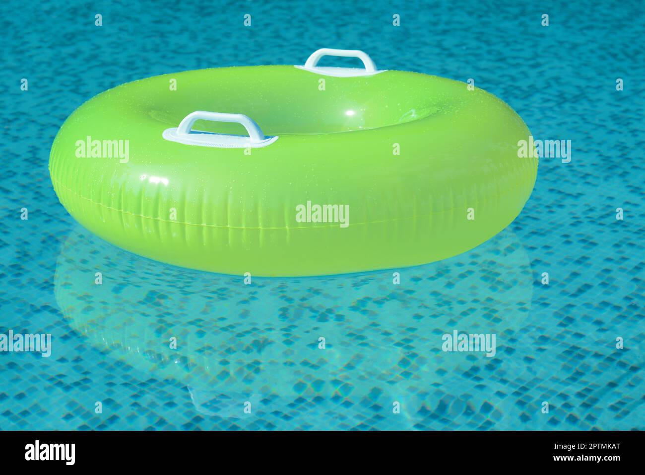 Light green inflatable ring floating in swimming pool Stock Photo - Alamy