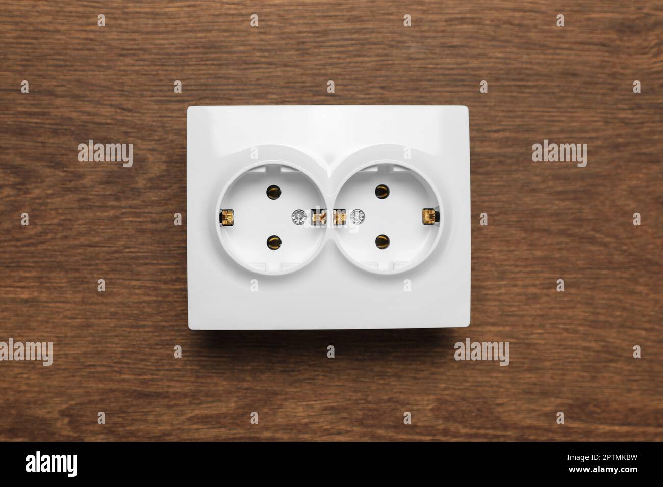 Modern plastic power socket on wooden table, top view Stock Photo - Alamy