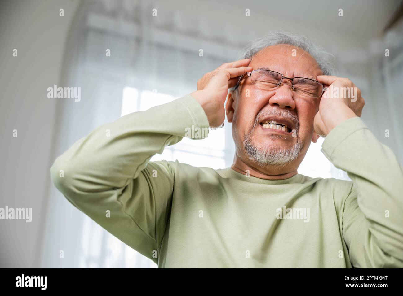 Headache. Sad Asian senior man chronic migraine pain massaging, old man ...