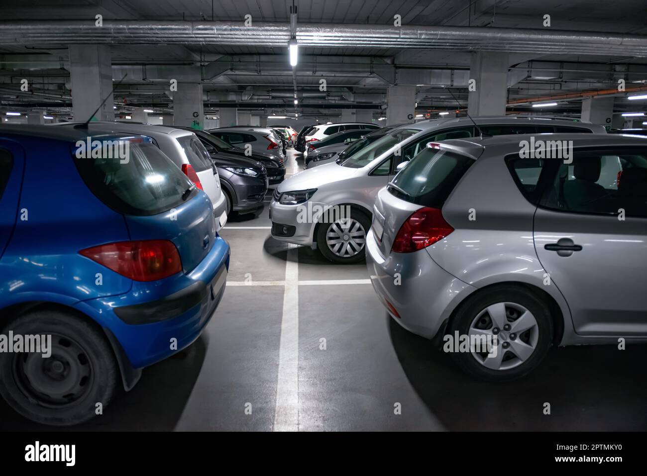 View of different cars in underground parking Stock Photo - Alamy