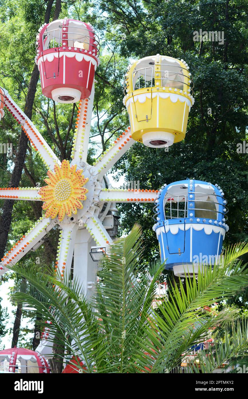 Observation wheel with colorful cabins in amusement park Stock Photo ...
