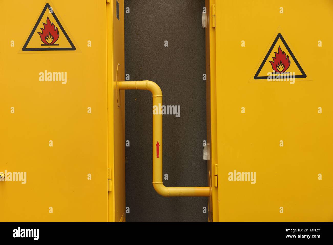 Yellow gas distribution cabinet near brown wall Stock Photo - Alamy