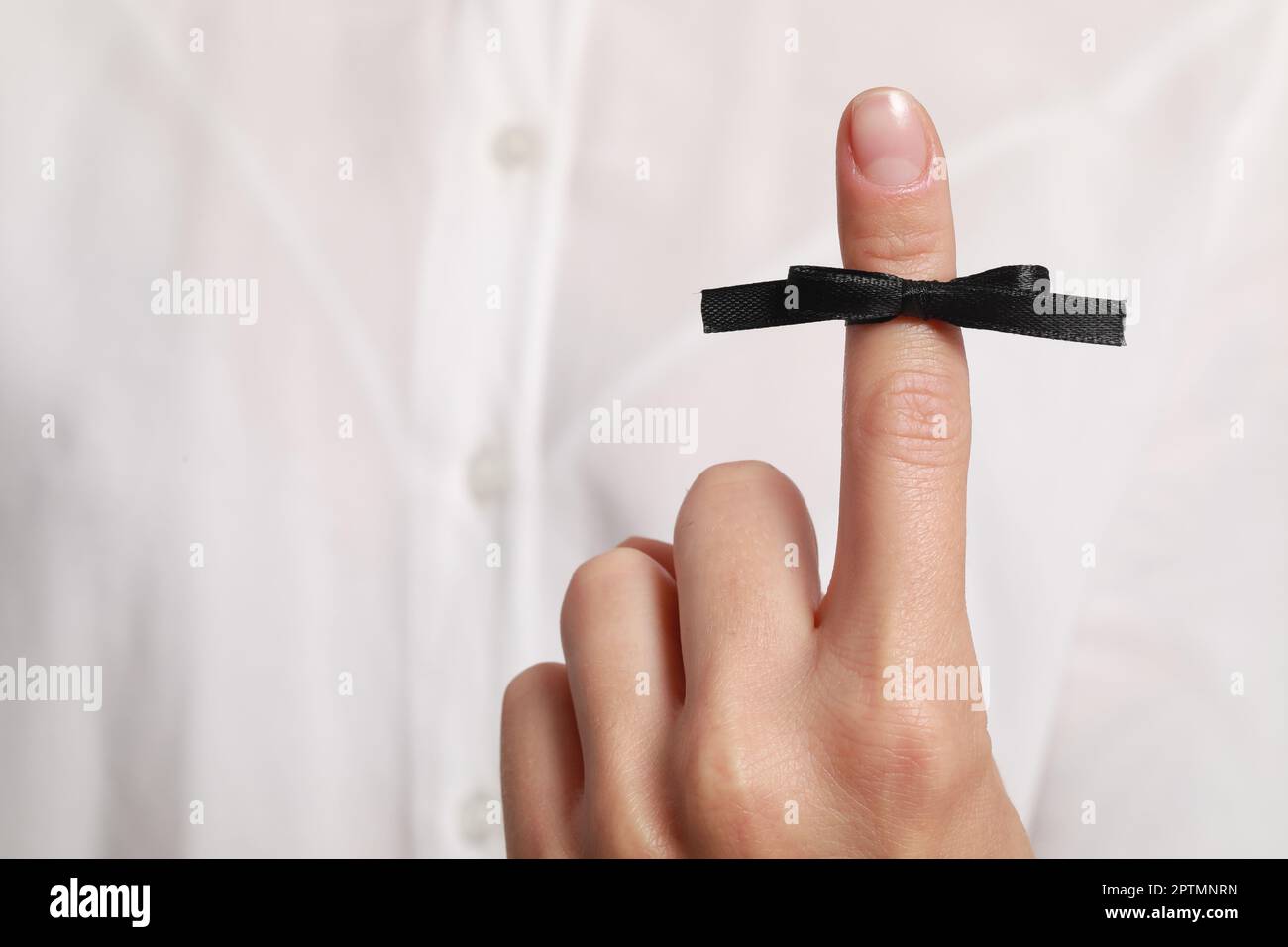 Woman index finger remember hi-res stock photography and images - Alamy