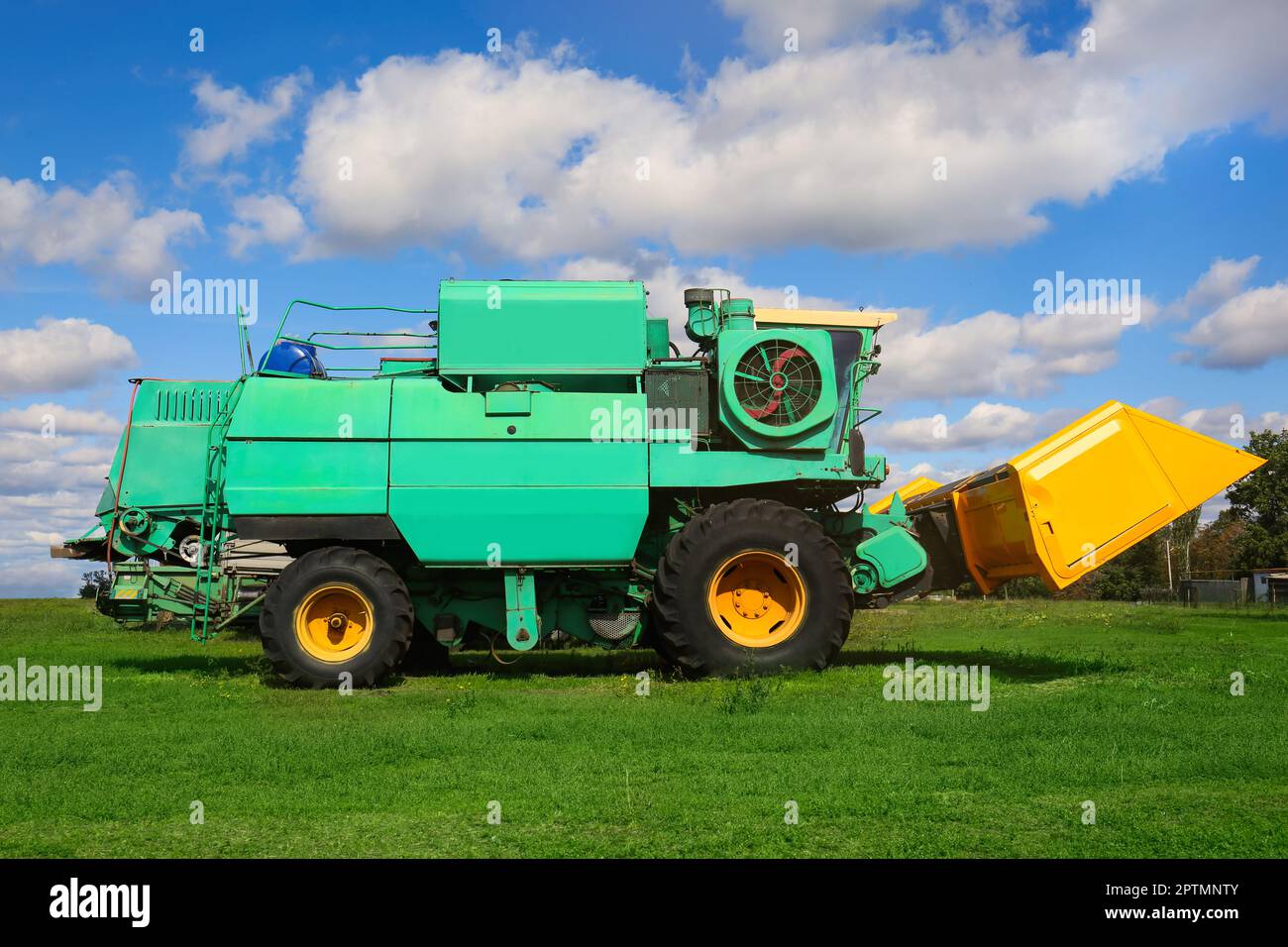 Modern combine harvester on green lawn with fresh grass Stock Photo - Alamy