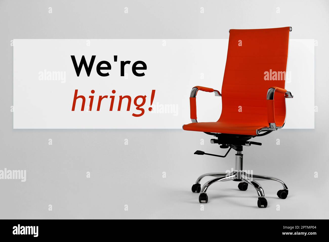 We`re hiring! Red office chair on light grey background Stock Photo - Alamy