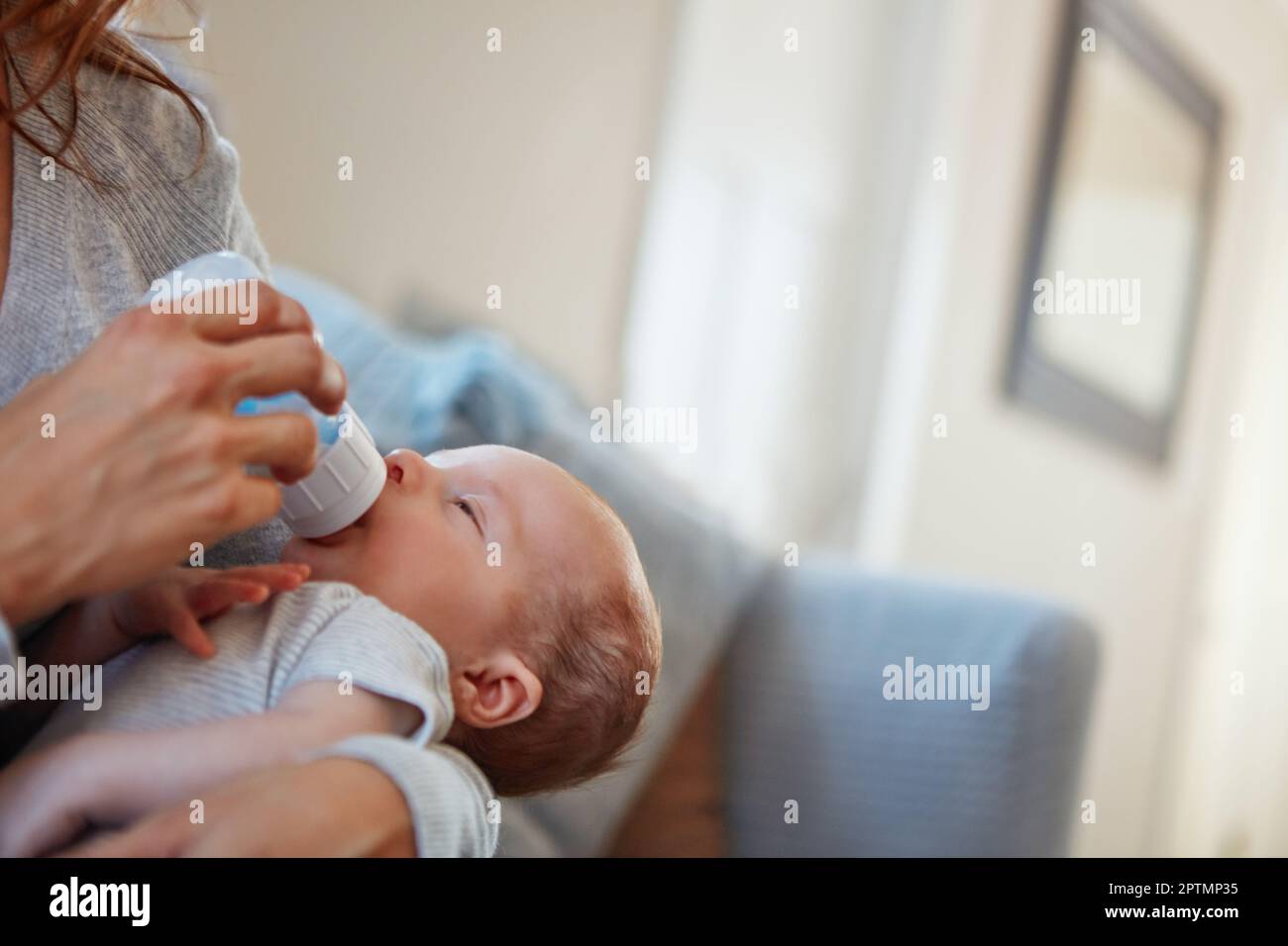 Falling asleep after hes filled his tummy. a mother feeding her newborn baby Stock Photo - Alamy