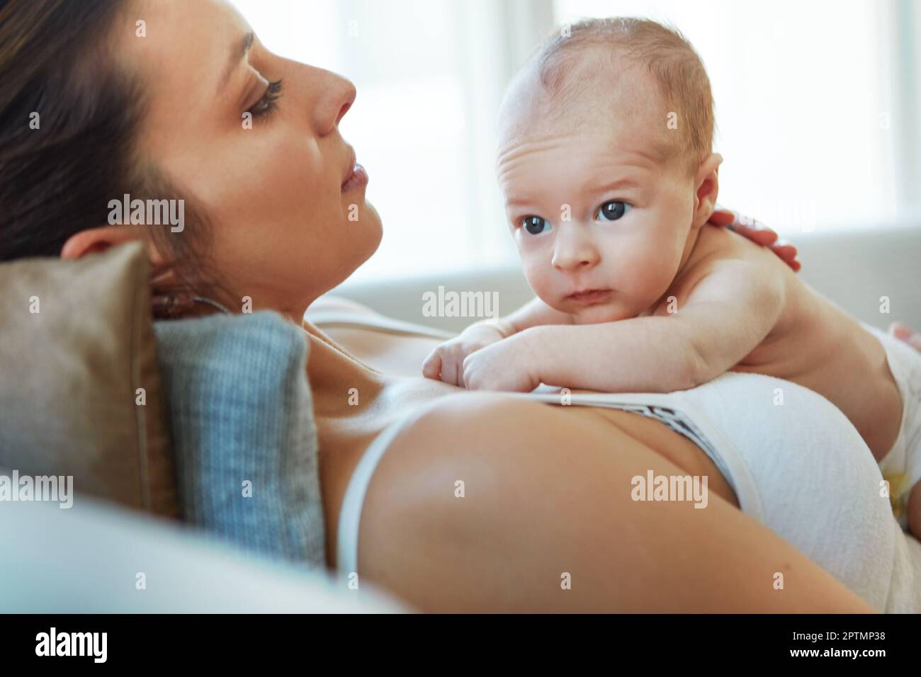 These are the best moments. a mother lying down with her newborn baby ...