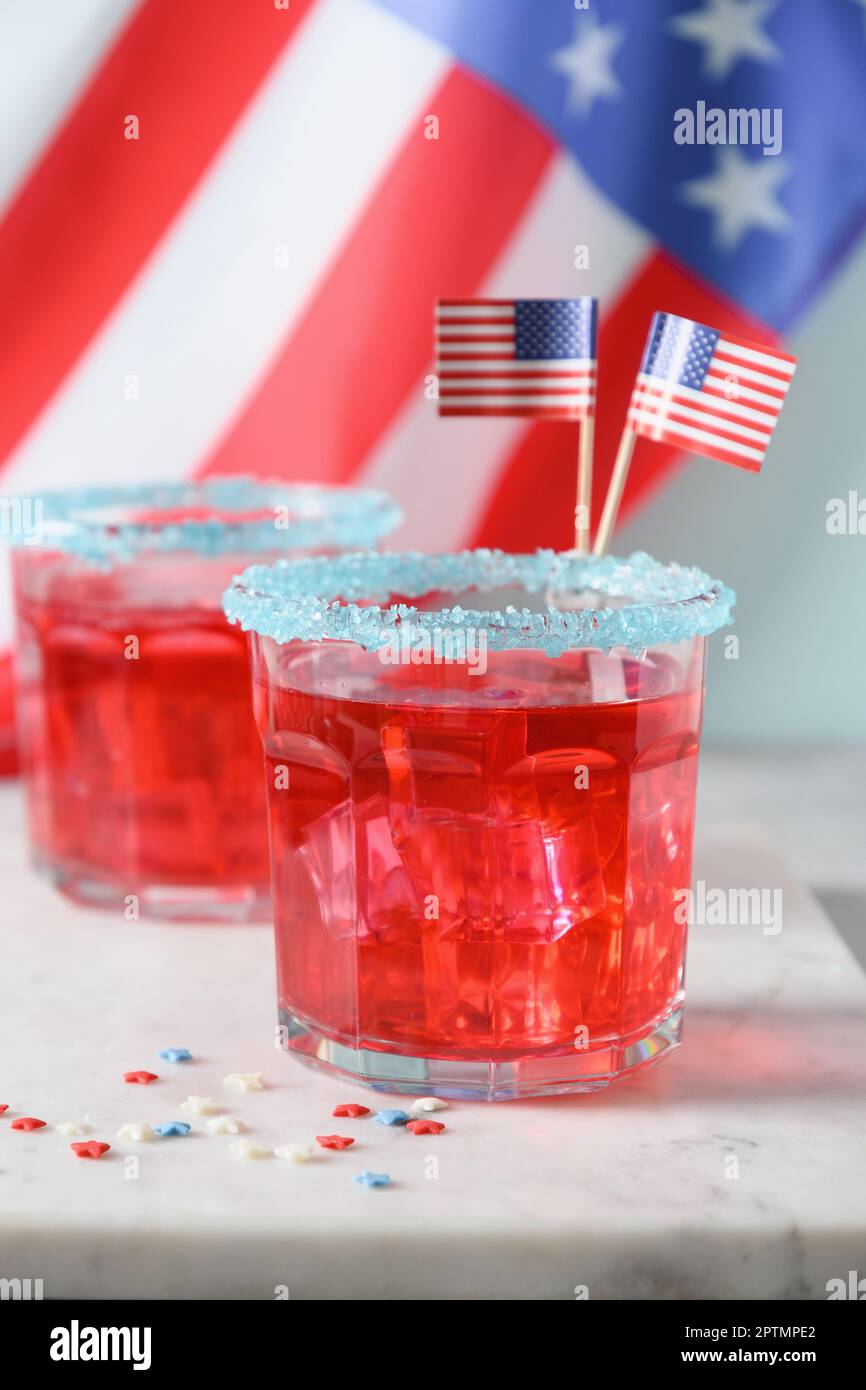 Patriotic red pomegranate margarita cocktail and USA flag as background ...