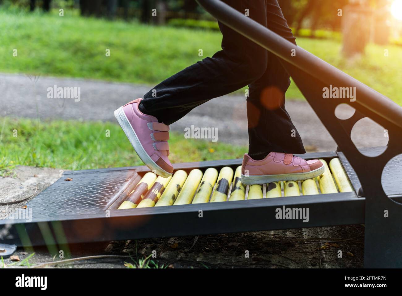 Close up of Child girl running on a treadmill for exercise at the ...