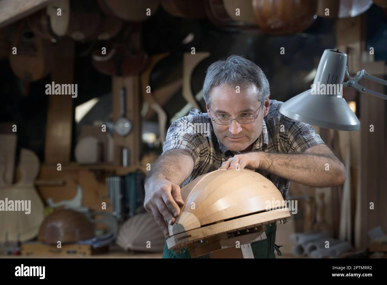 Craftsman manufacturing lute at workshop Stock Photo - Alamy
