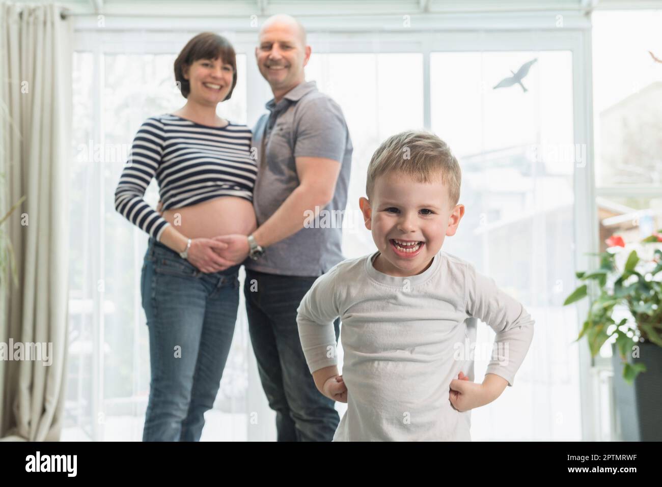 Portrait of boy with parents at home Stock Photo - Alamy