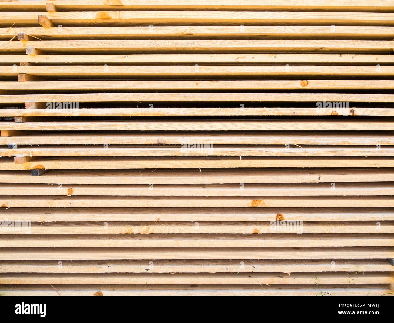 Full framed view of new softwood boards stacked parallel on top of each ...