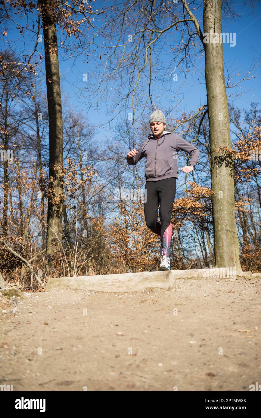 Man doing exercise at obstacle course on fitness trail in forest Stock ...