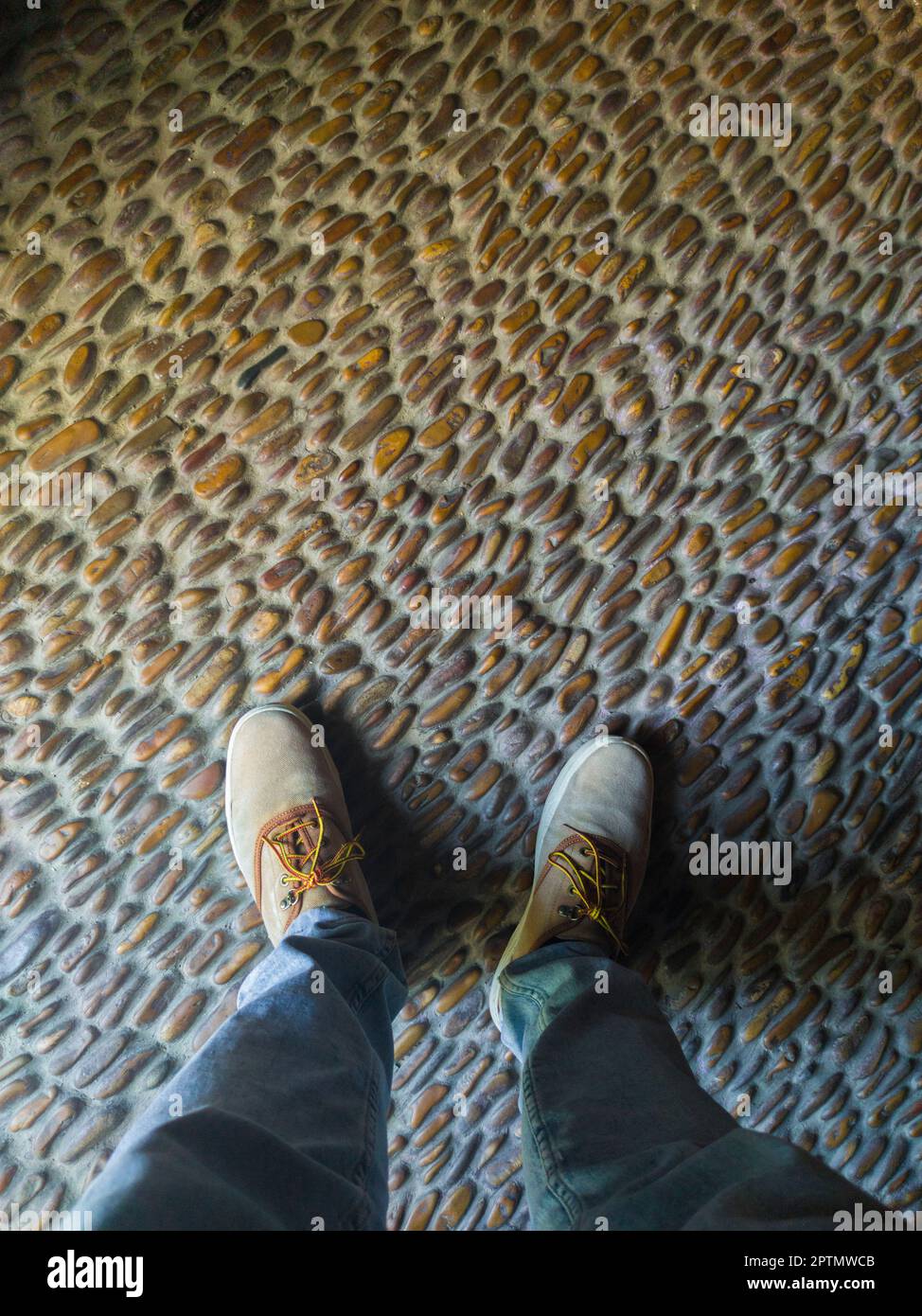 Man stepping on pebbles floor. Traditional south spanish flooring ...