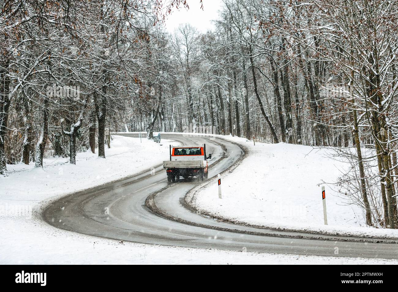 Mini truck passing on a highway with snow slush and snow fall, winter ...