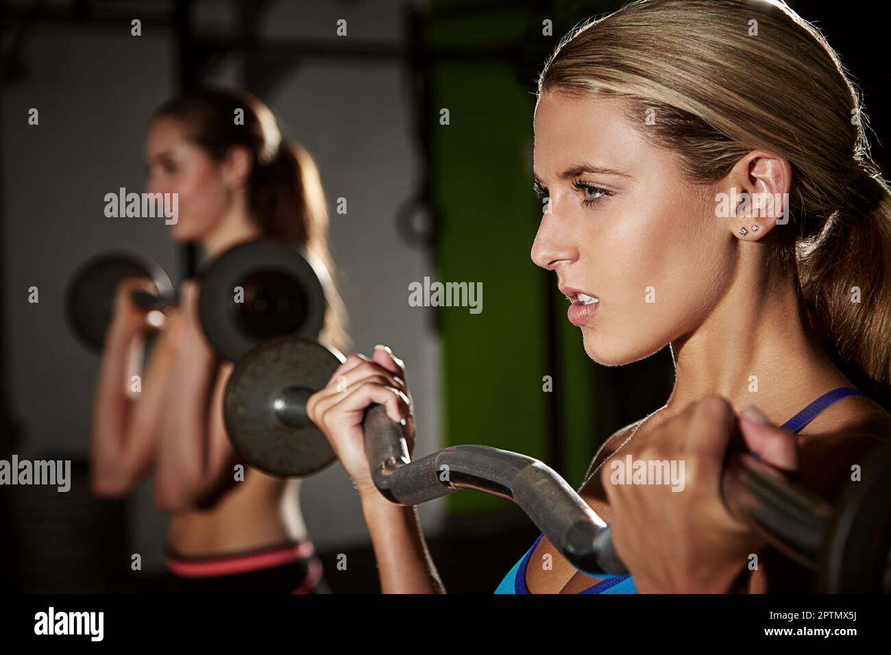 You cant go wrong with strong. two young women working out with weights ...