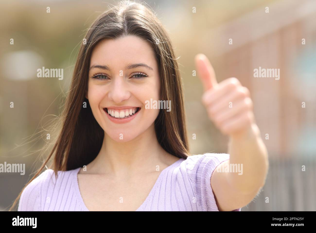 Happy teen gestures thumb up standing in the street Stock Photo - Alamy