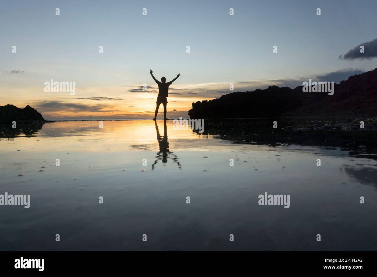 Silhouette man standing arms outstretched hi-res stock photography and ...