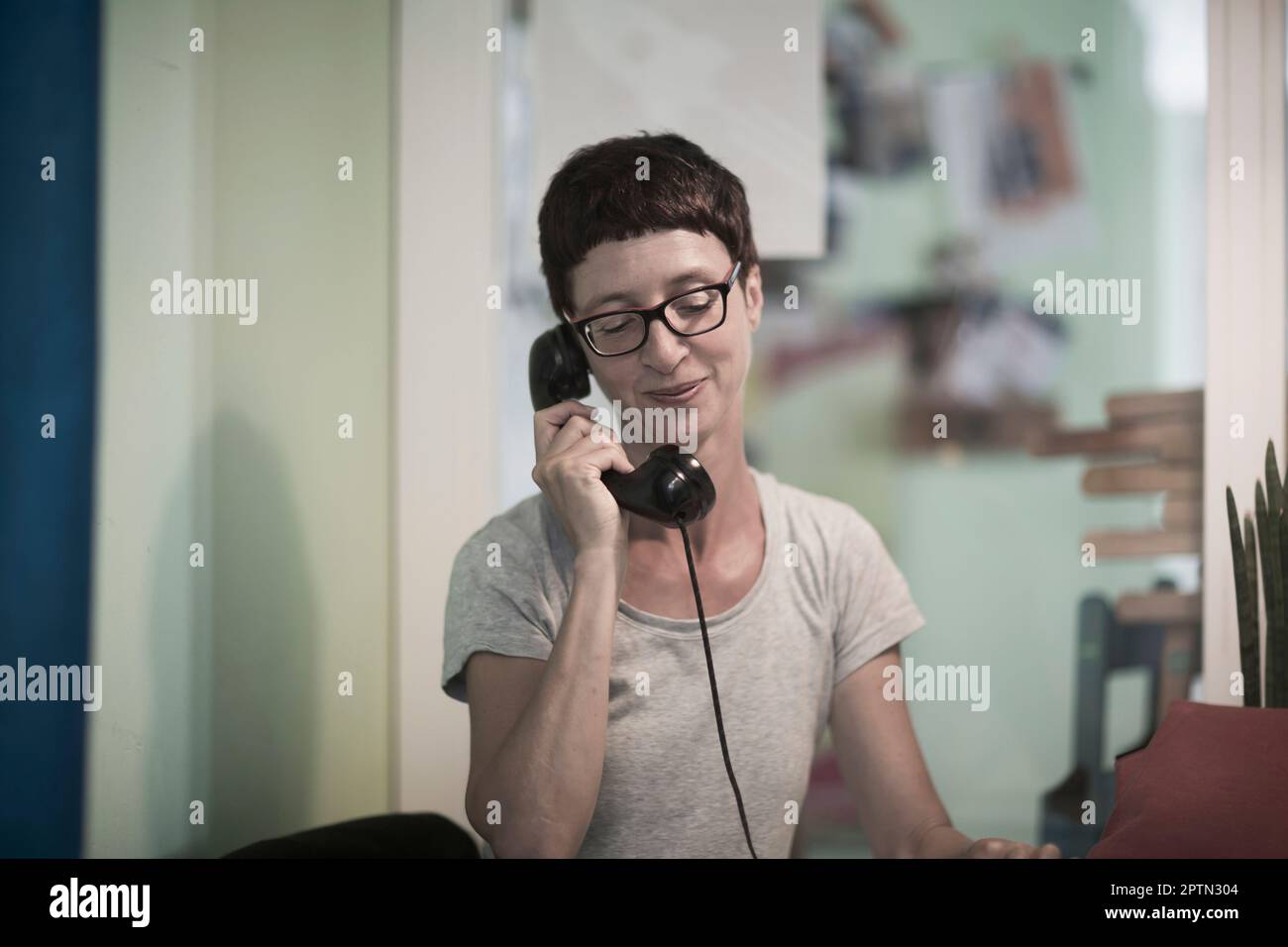 Mature woman talking on landline Phone in the office, Freiburg im ...