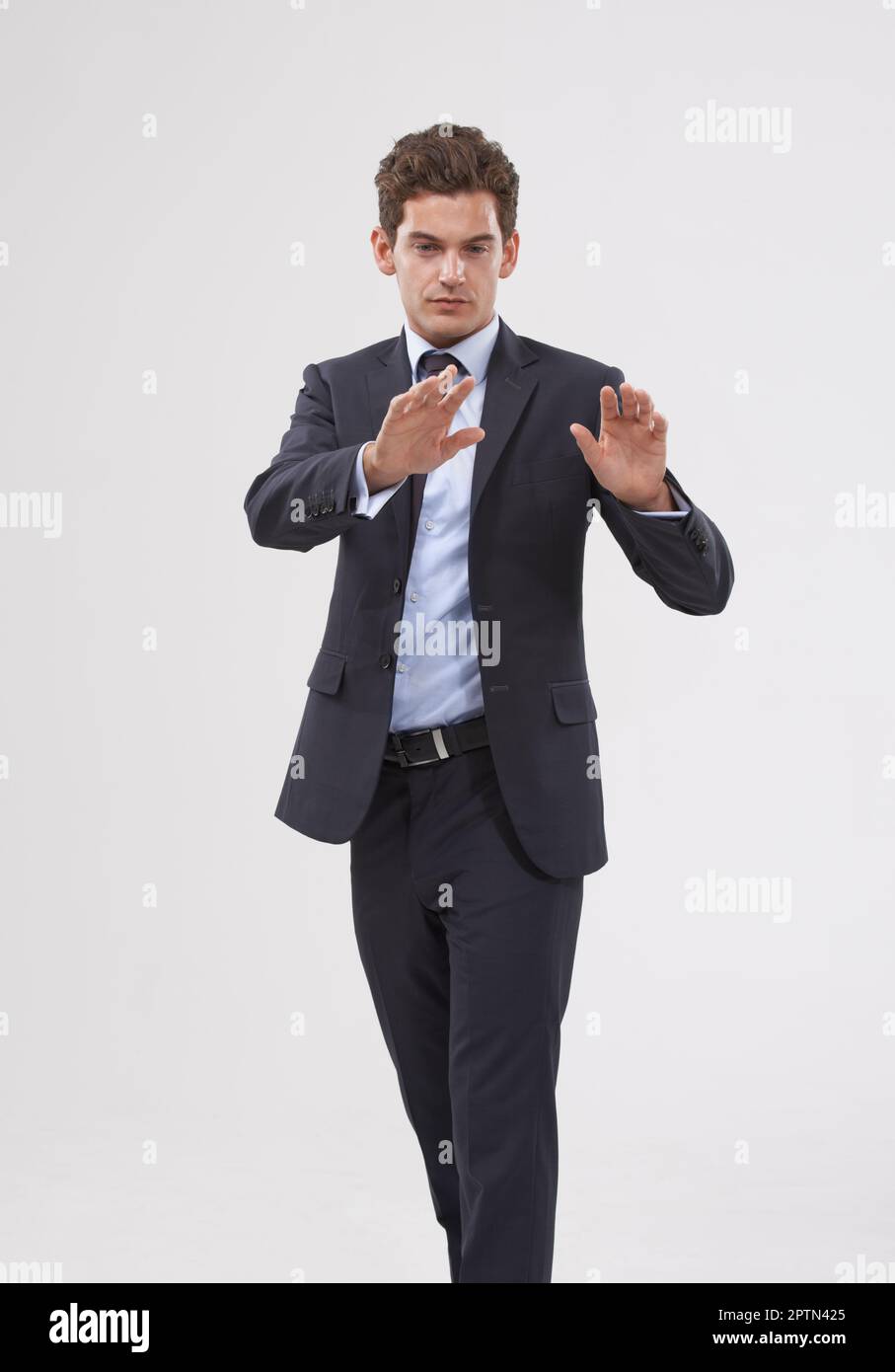 Moving toward the future. Businessman holding up his hand in a stop ...