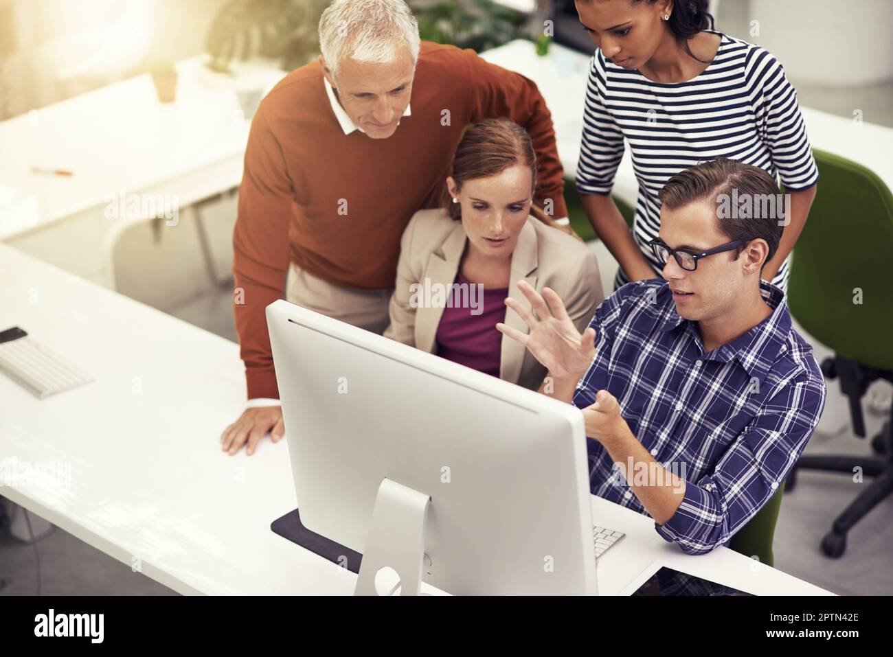 Group of men sharing a computer screen hi-res stock photography and ...
