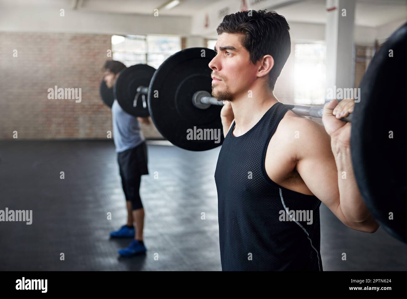 That was a clean lift. young men working out with weights in the gym ...