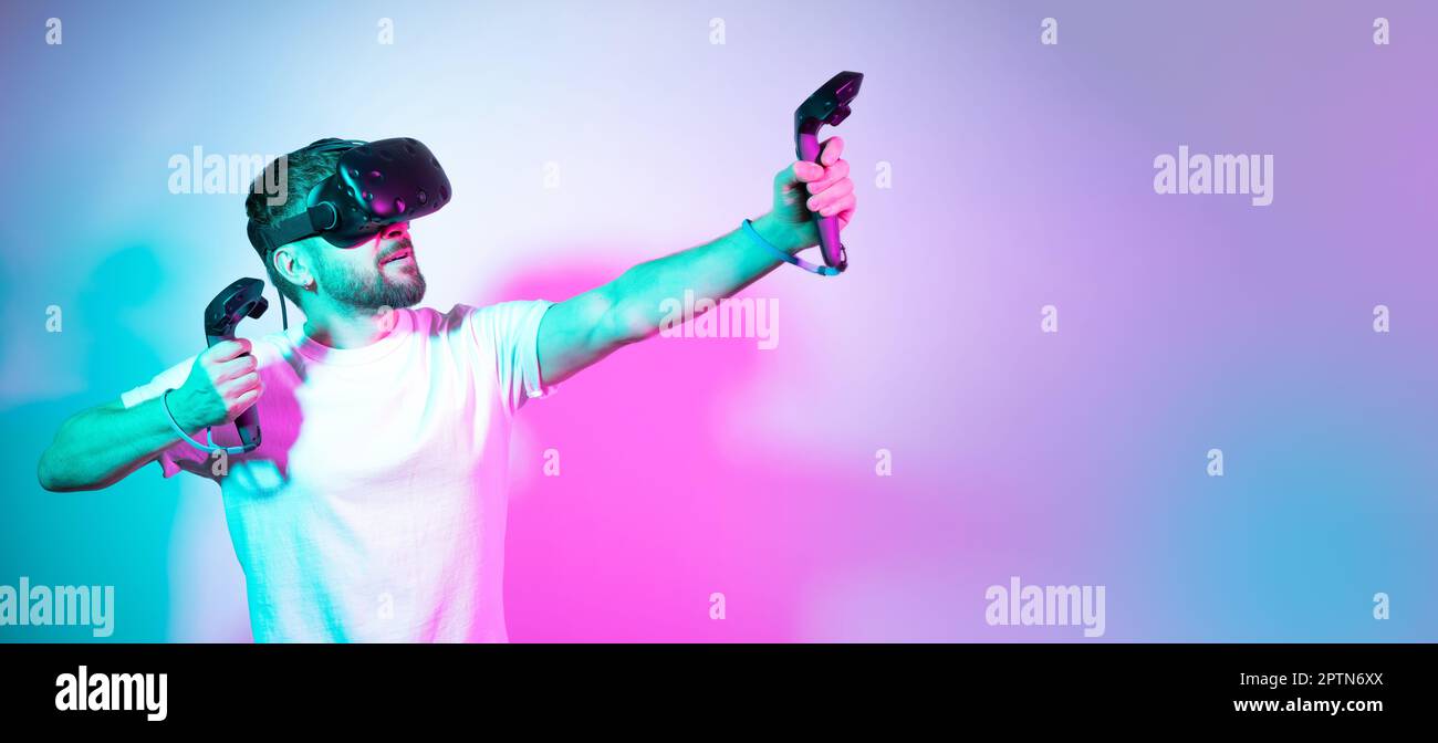 Concept modern hobby. Bearded millennial man in VR glasses plays in ...