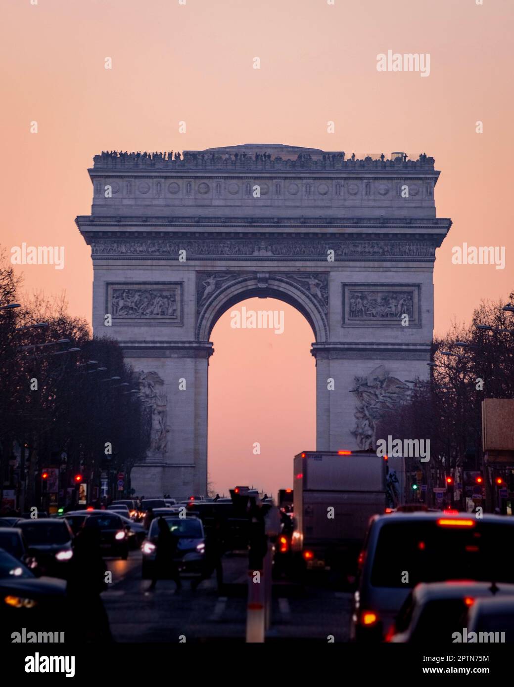 view of arc de triomphe over sunset from champs elysees Stock Photo - Alamy