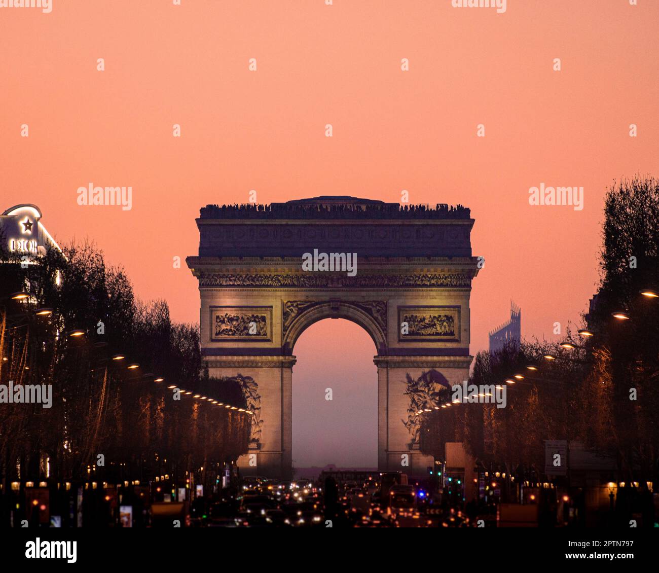 view of arc de triomphe over sunset from champs elysees Stock Photo - Alamy