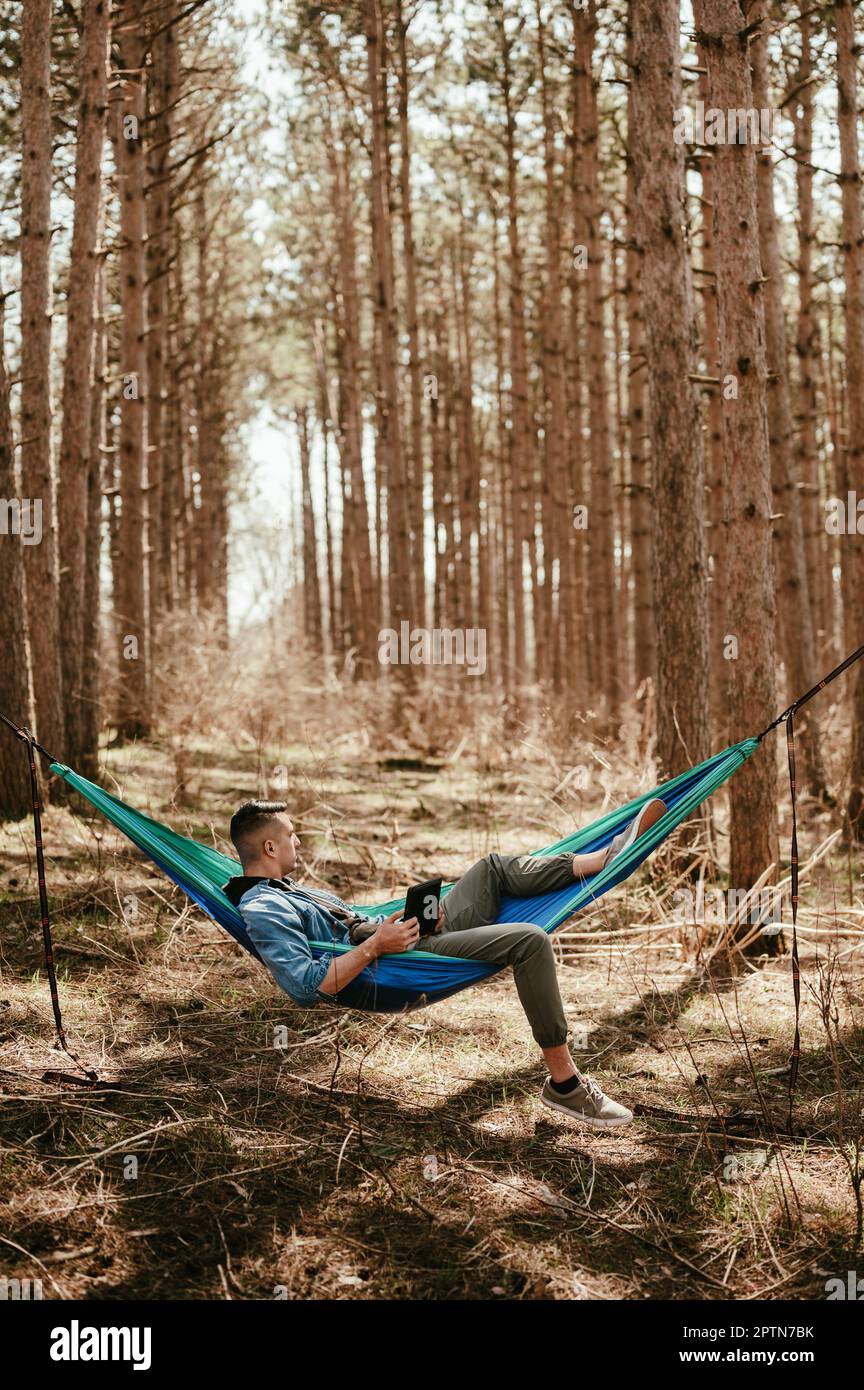 Guy relaxing in hammock digital hi-res stock photography and images - Alamy