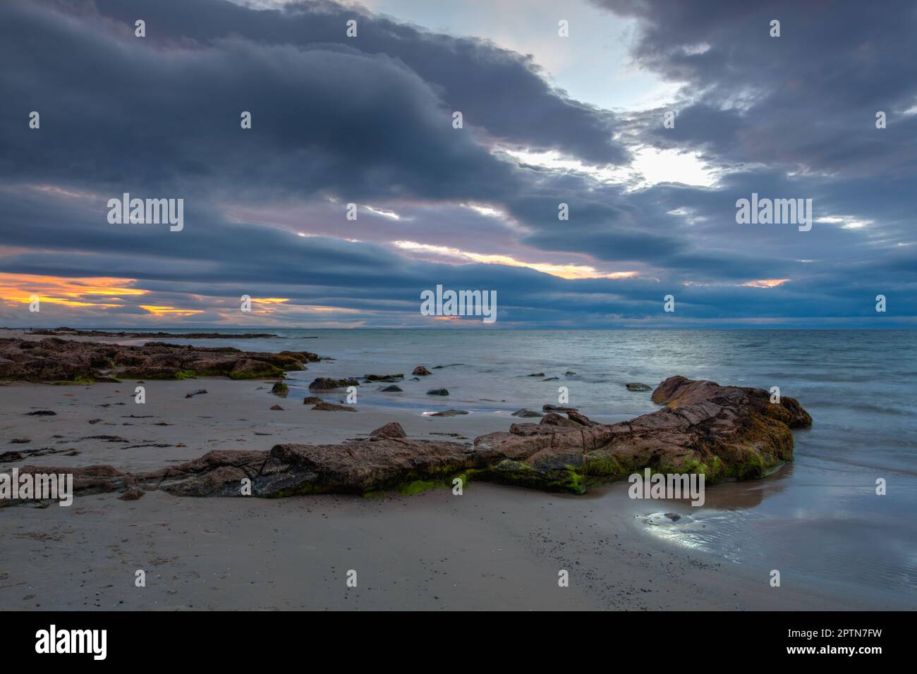 Dramatic sunset on the beach under Covesea Skerries Lighthouse Stock ...