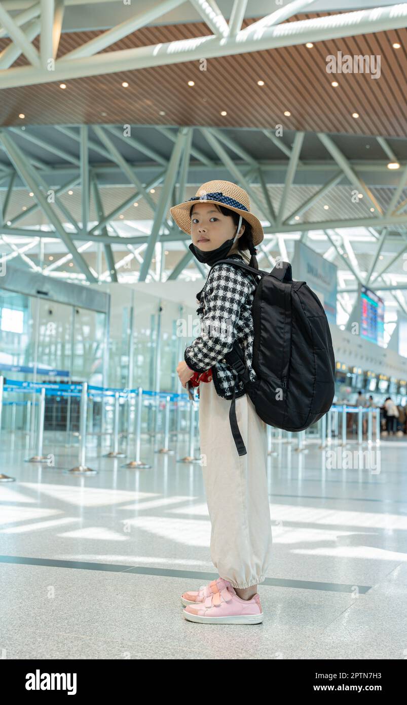Cute happy child girl with backpack at airport terminal. Kid and family ...
