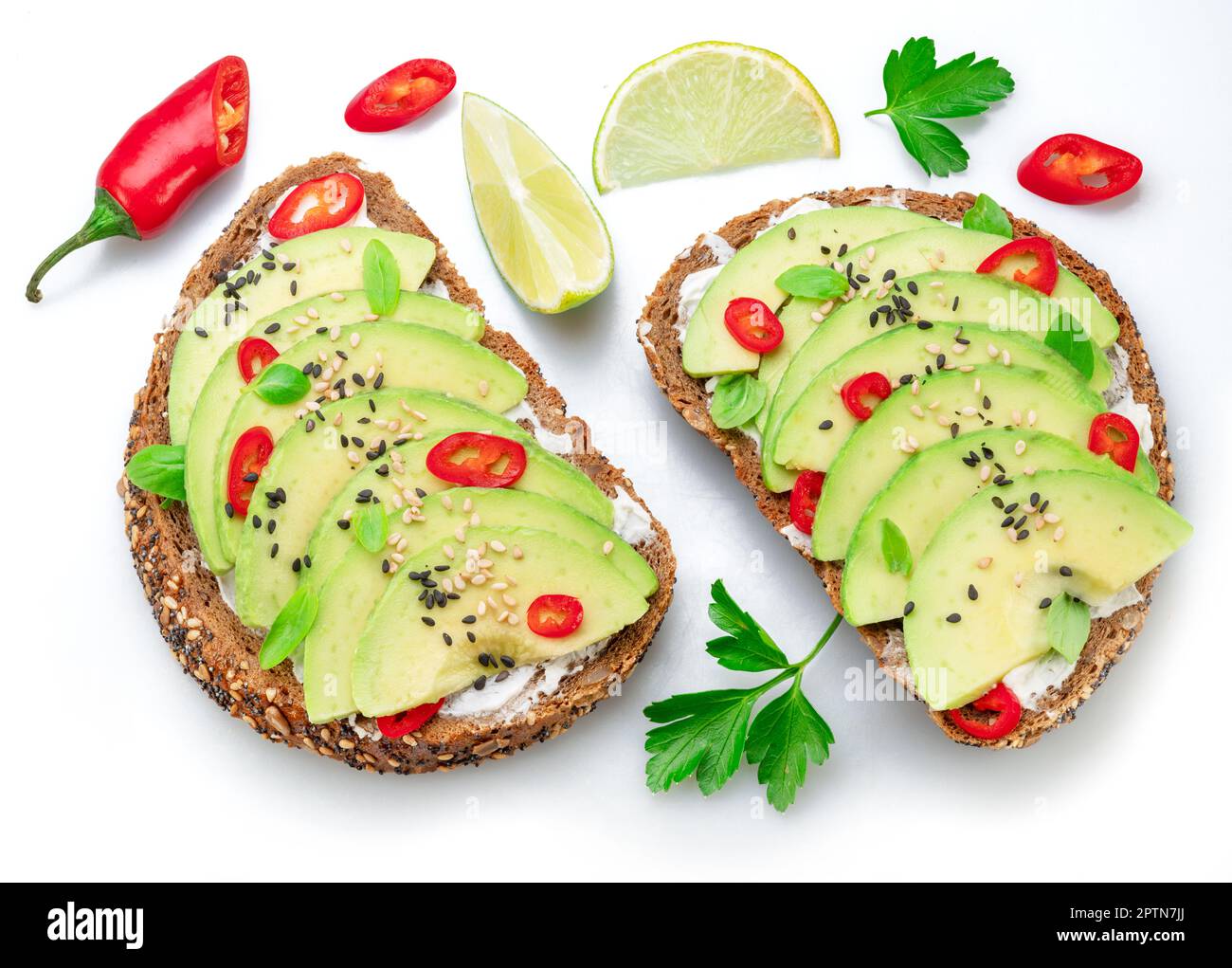 Avocado toasts - bread with avocado slices, pieces of chilli pepper and ...
