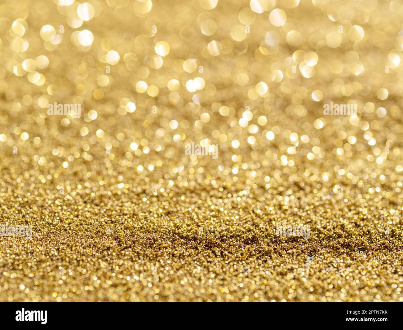 Sparkling golden powder. Festive background Stock Photo - Alamy