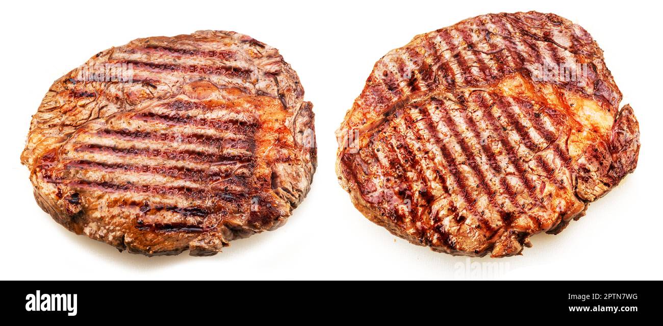 Two grilled ribeye steaks isolated on white background Stock Photo - Alamy
