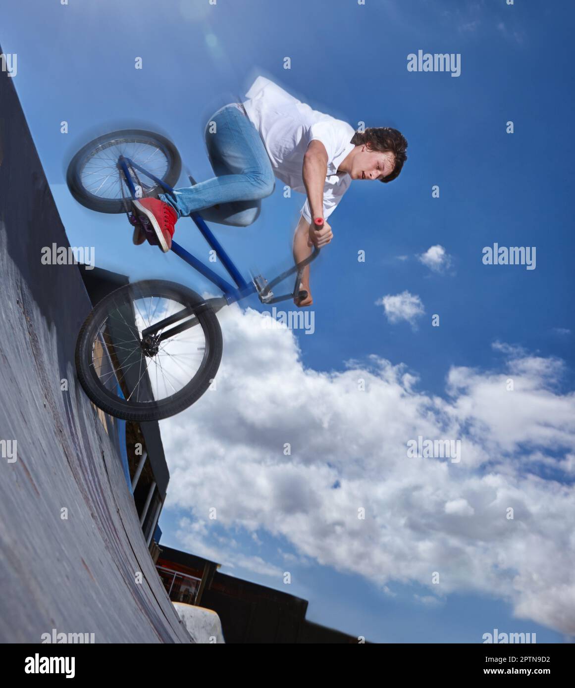 Practicing for the x games. Full length shot of a teenage boy riding a ...