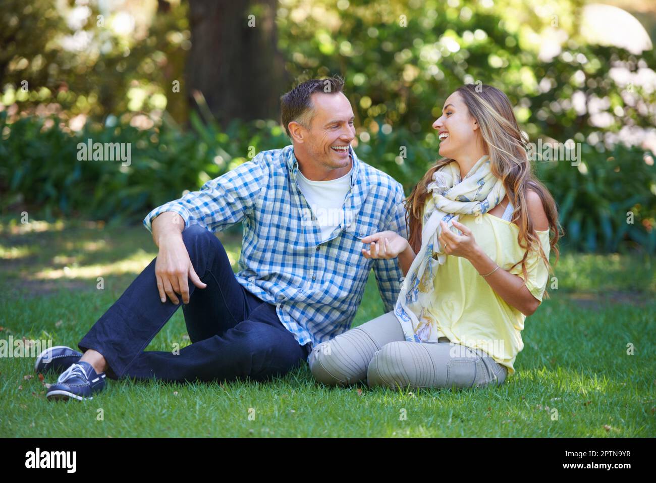 Finding a quiet place to chat. an affectionate couple enjoying the summer sun Stock Photo - Alamy