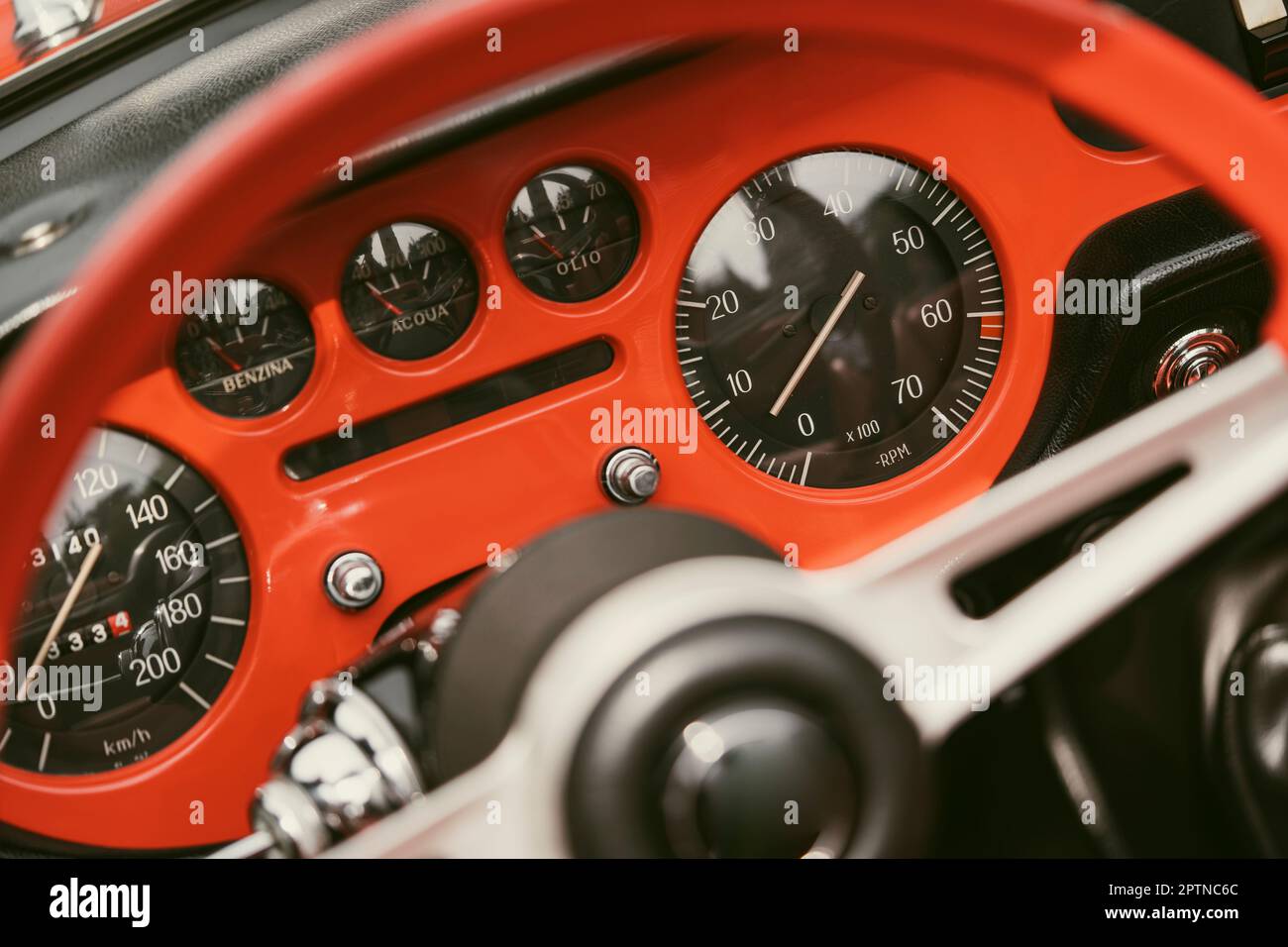 Close up hot of a vintage dashboard with various gauges on a retro car ...
