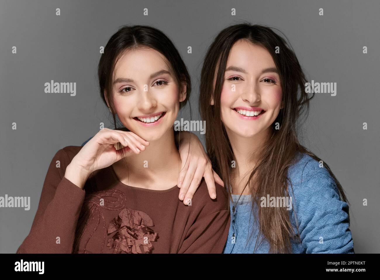 Two girls with smooth dark hair expressing emotions Stock Photo - Alamy