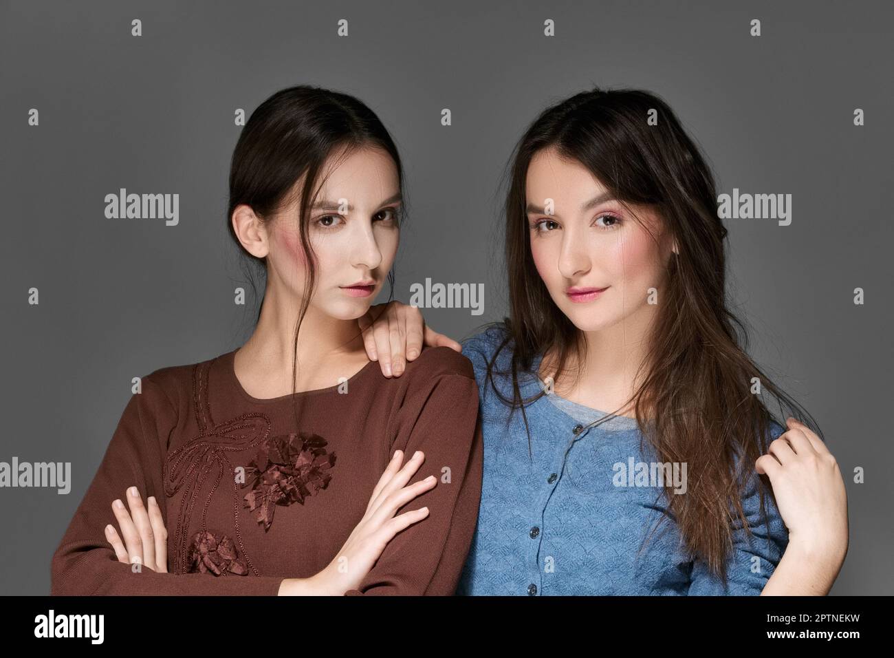Two girls with smooth dark hair expressing emotions Stock Photo - Alamy