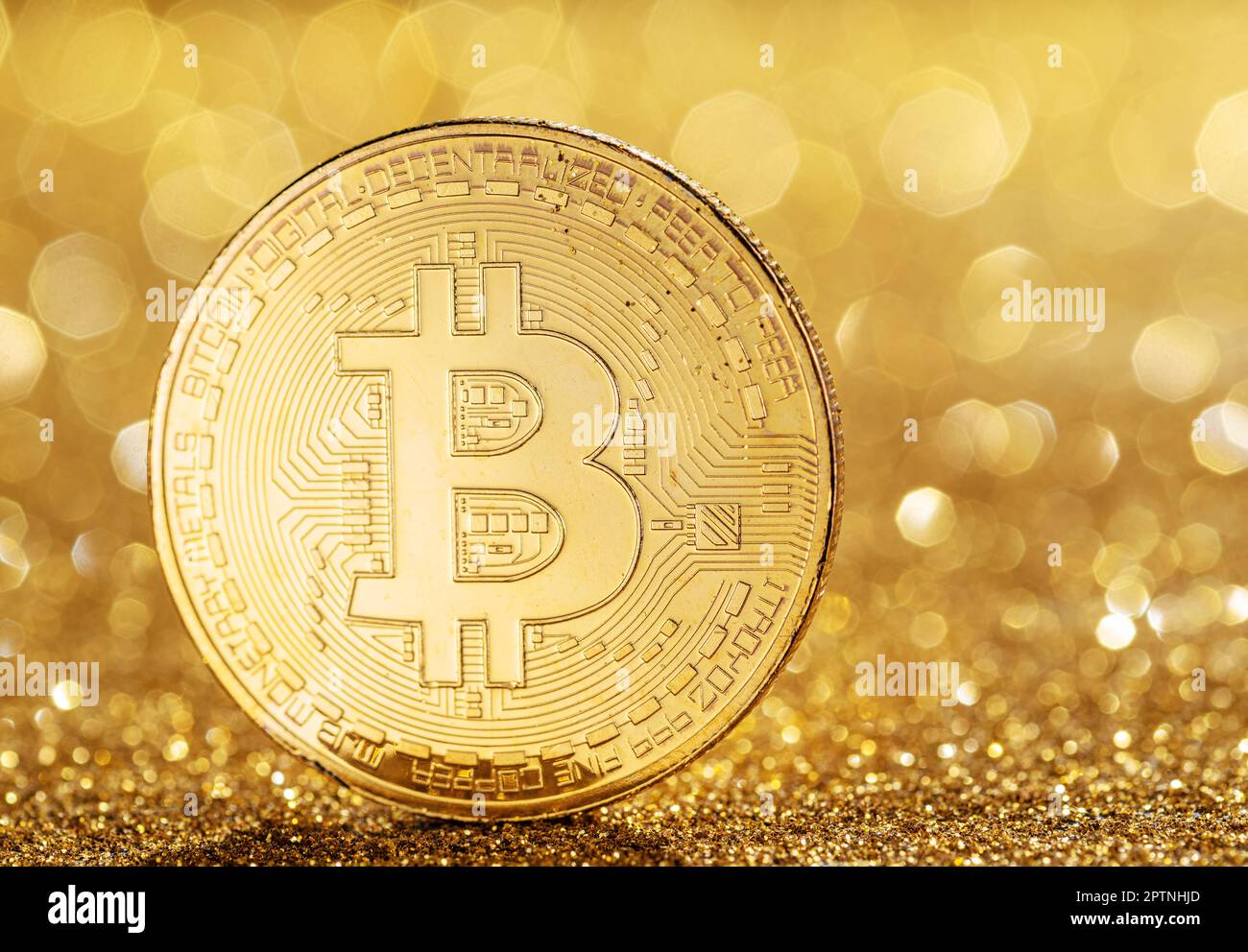Gold bitcoin coin at the blazing gold background. Conceptual picture of ...