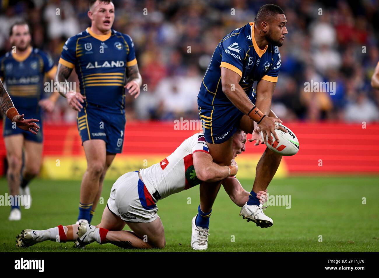 Ofahiki Ogden of the Eels is tackled by Tyson Gamble of the Knights ...