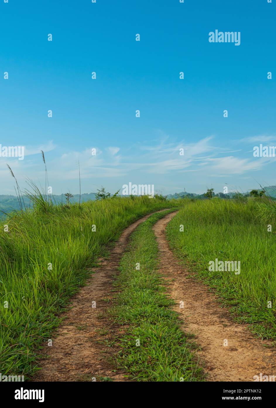Landscape view of countryside dirt road path crosses the hills with ...
