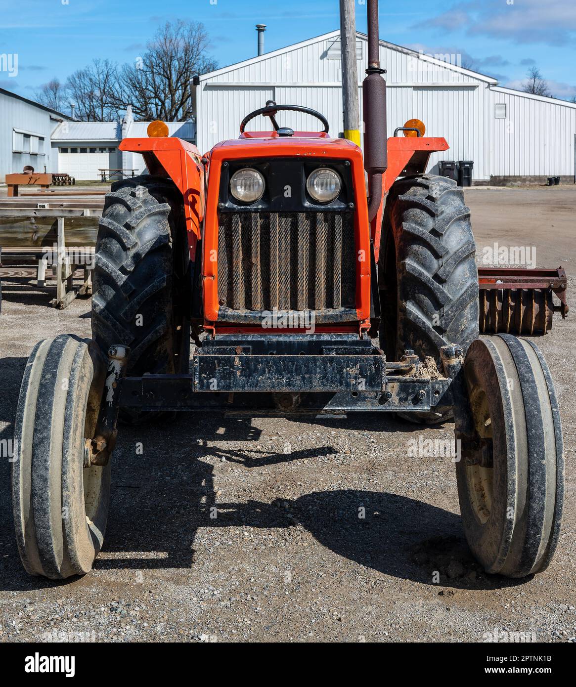 Front of a small farm tractor representing machinery commonly used in ...