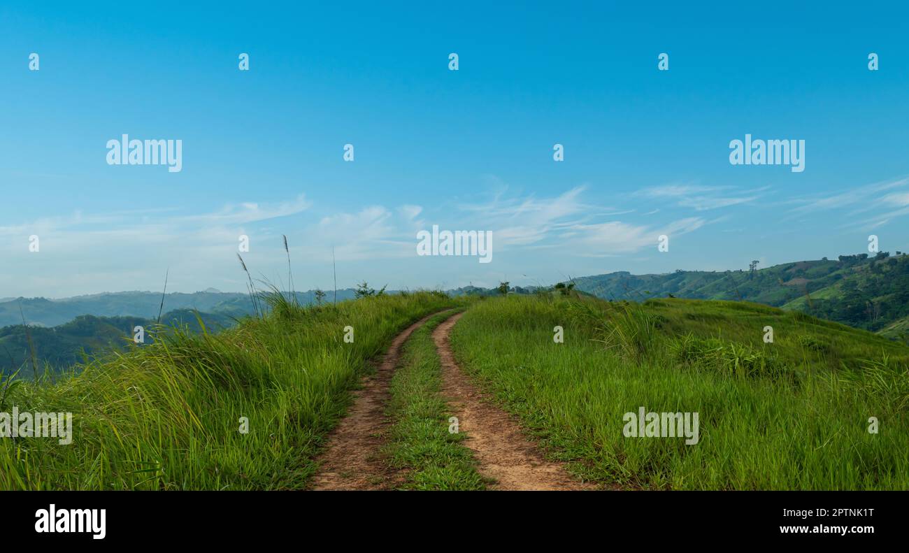 Landscape view of countryside dirt road path crosses the hills with ...