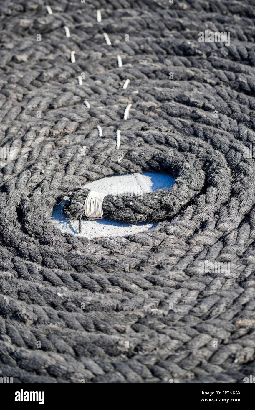 Twisted gray rope on a boat deck Stock Photo - Alamy