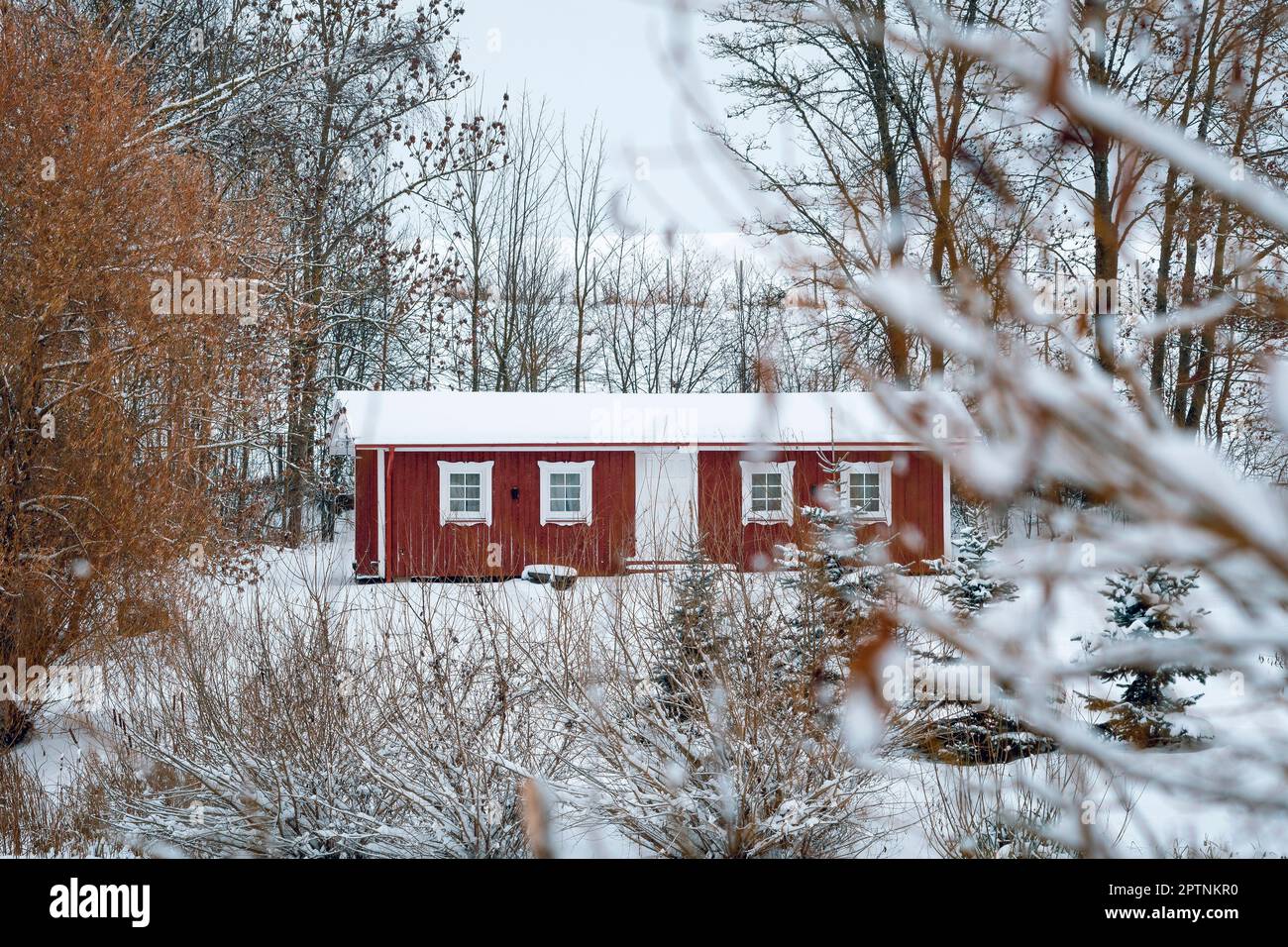 Winter landscape with snow covered red cabin Stock Photo - Alamy