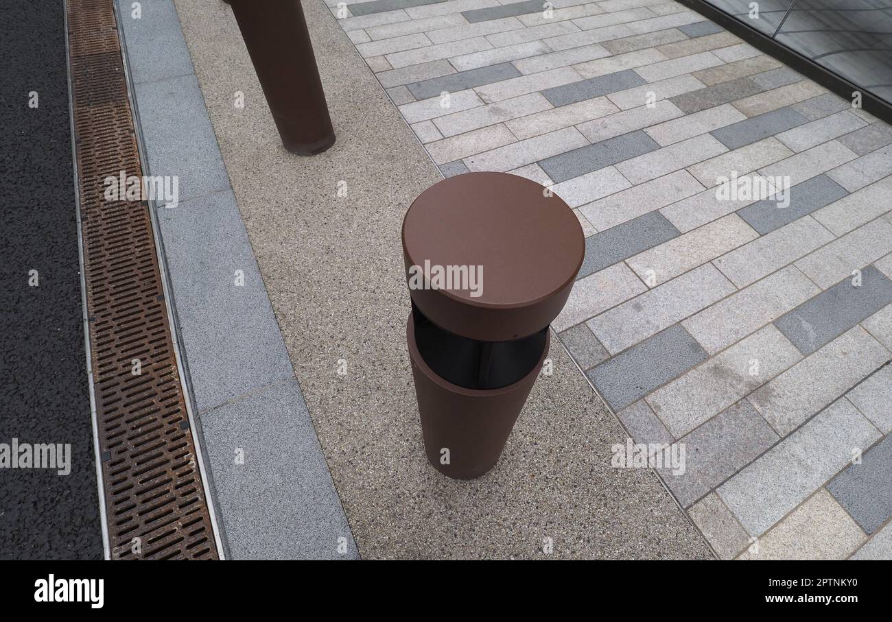 pavement with street furniture, manhole and stone tiles Stock Photo - Alamy