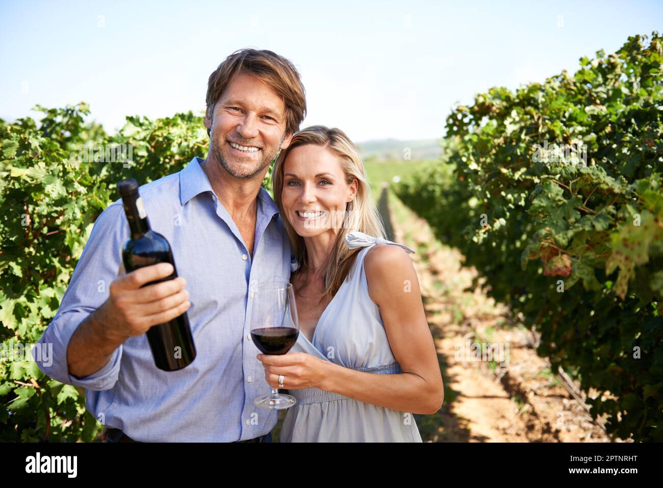 Celebrating their anniversary. Portrait of a couple enjoying wine ...